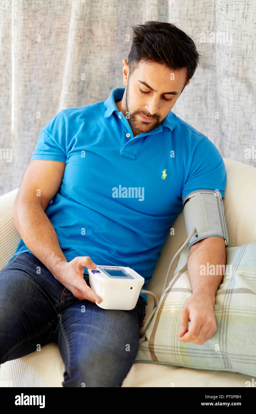 Man checking his blood pressure Stock Photo - Alamy