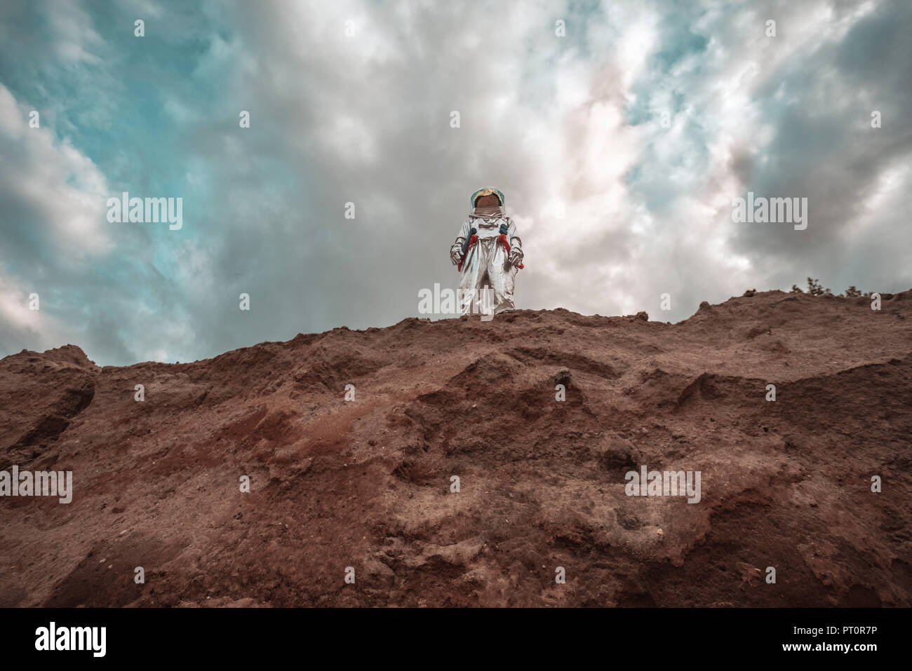 Spaceman standing on slope of nameless planet Stock Photo - Alamy