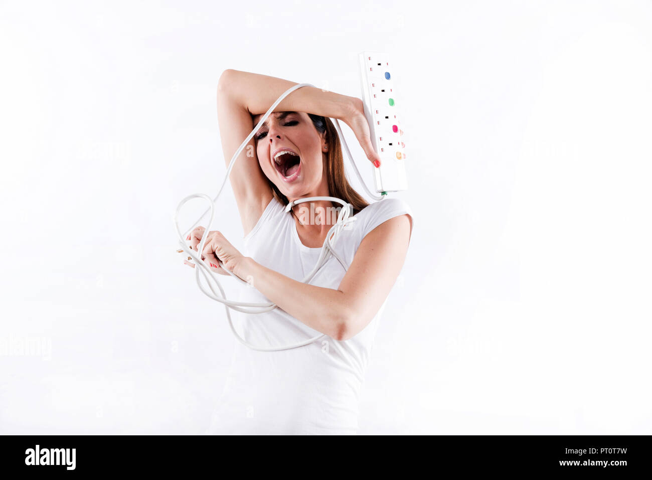 A beautiful young woman screaming with power cables in her hands Stock ...