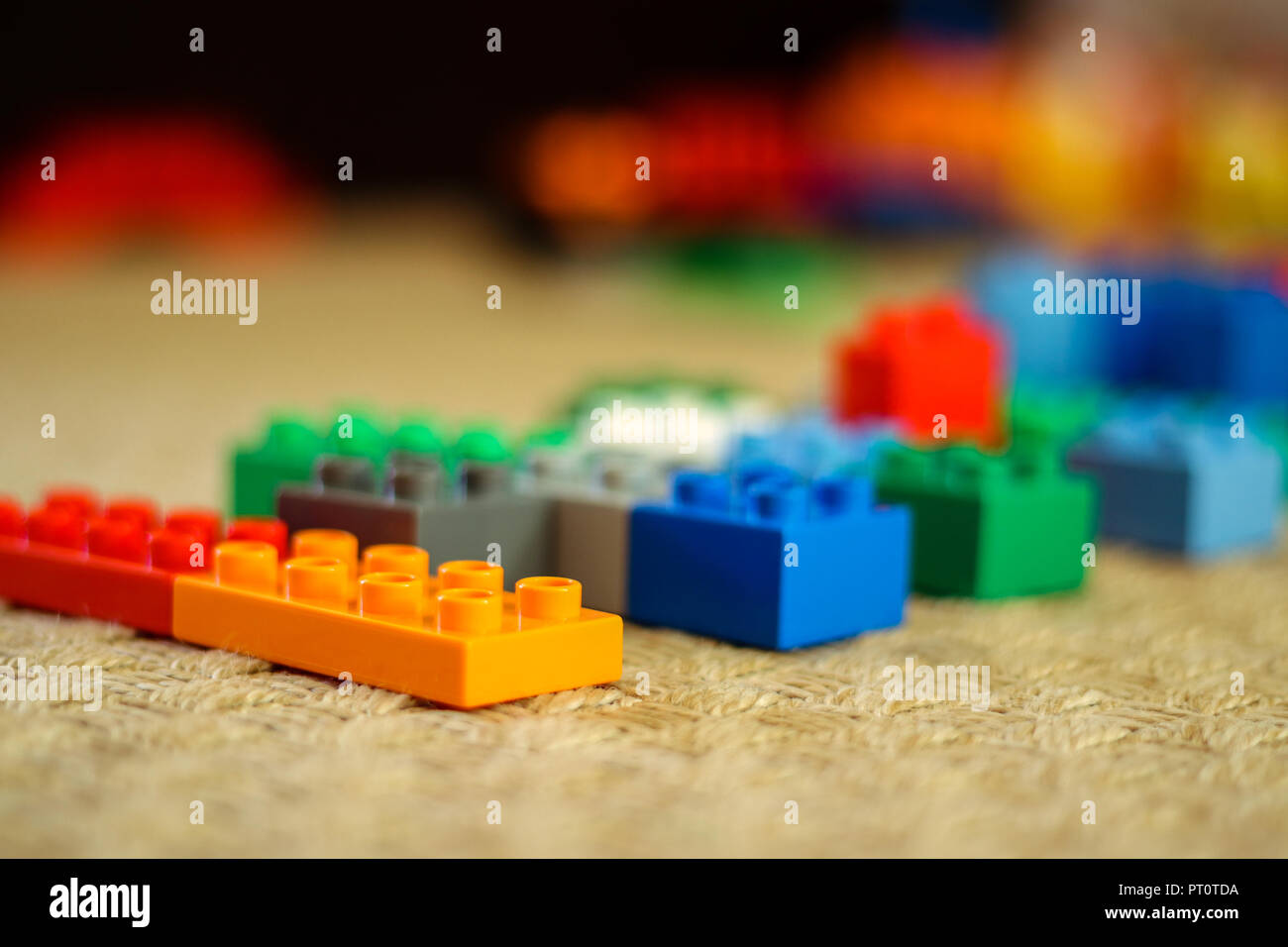 Plastic toy building blocks sorted in the line with defocused ...