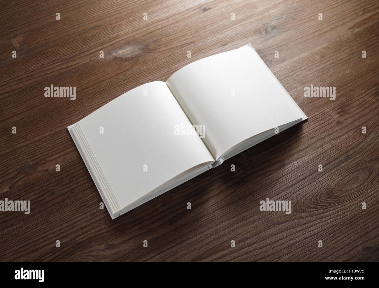 Blank open book on wooden background. Mock-up for graphic designers ...