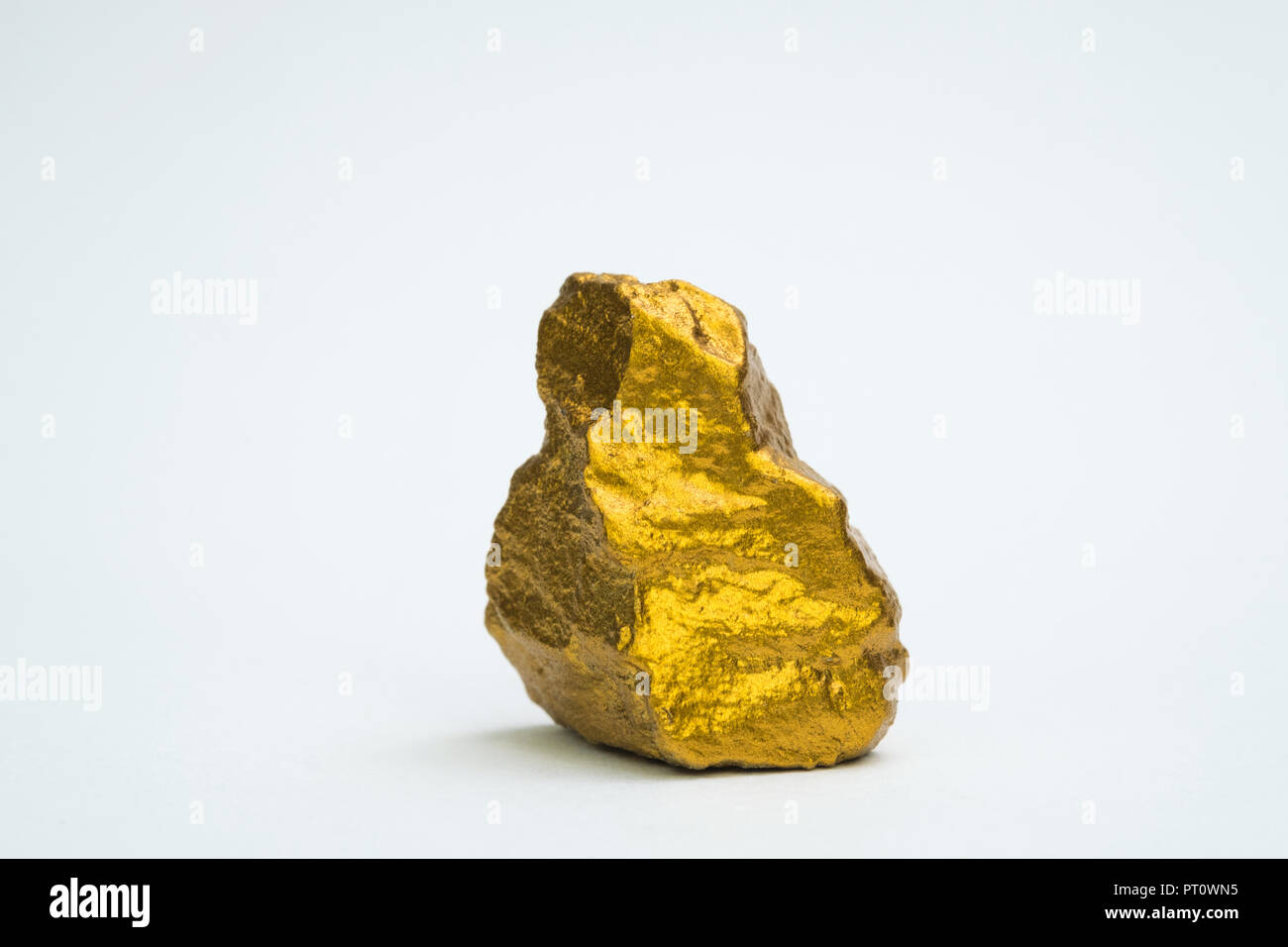 Closeup of gold nugget or gold ore on white background, precious stone ...