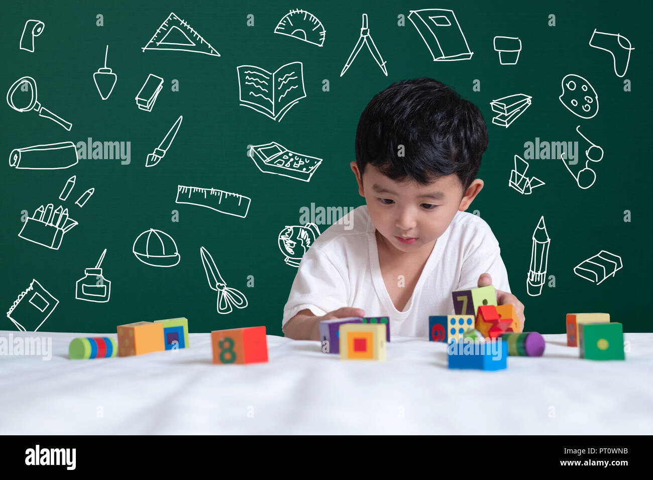 Asian kid learning by playing with his imagination about stationery ...