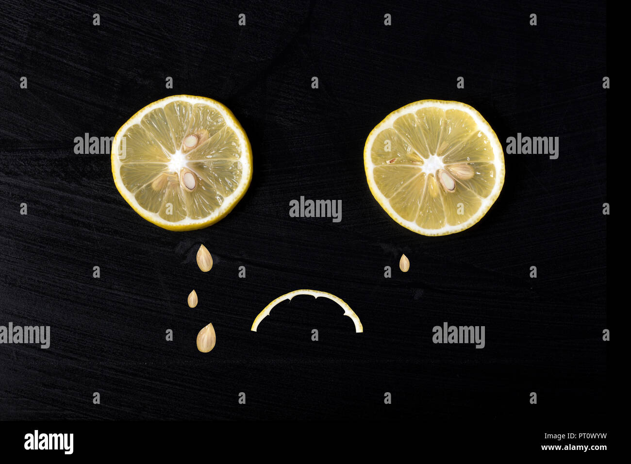 sad crying, under the bones, smile from lemons on a dark background ...