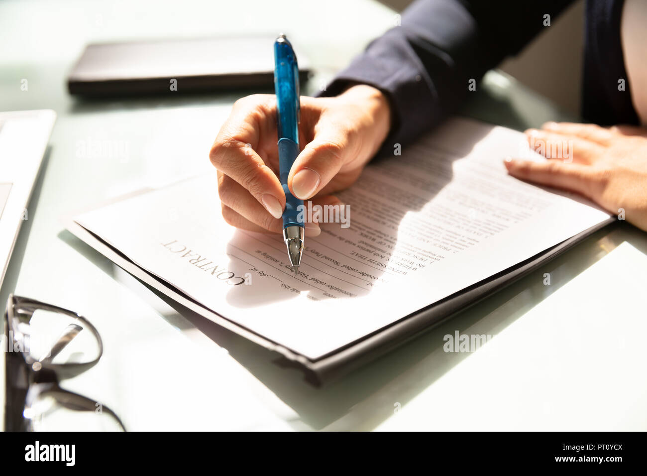 Close-up Of A Businesswoman's Hand Filling Contract Form Stock Photo ...