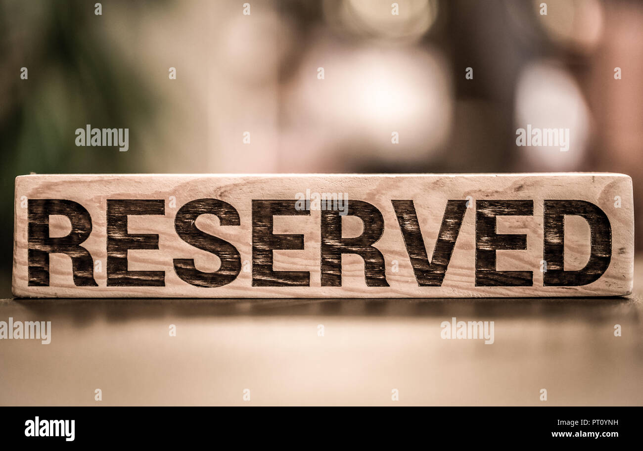 wooden sign saying reserved,close-up ,background ,concept hotels and ...