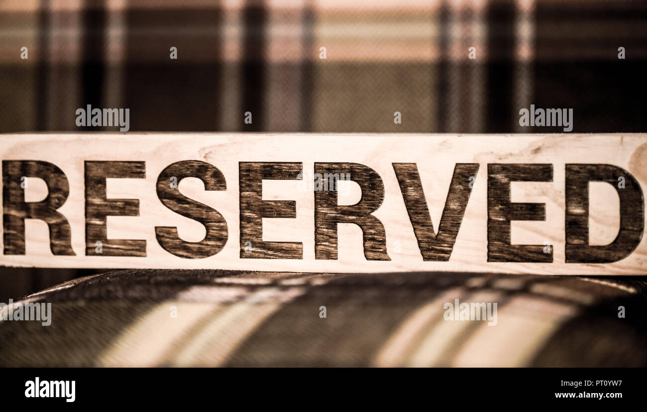 wooden sign saying reserved,close-up ,background ,concept hotels and ...