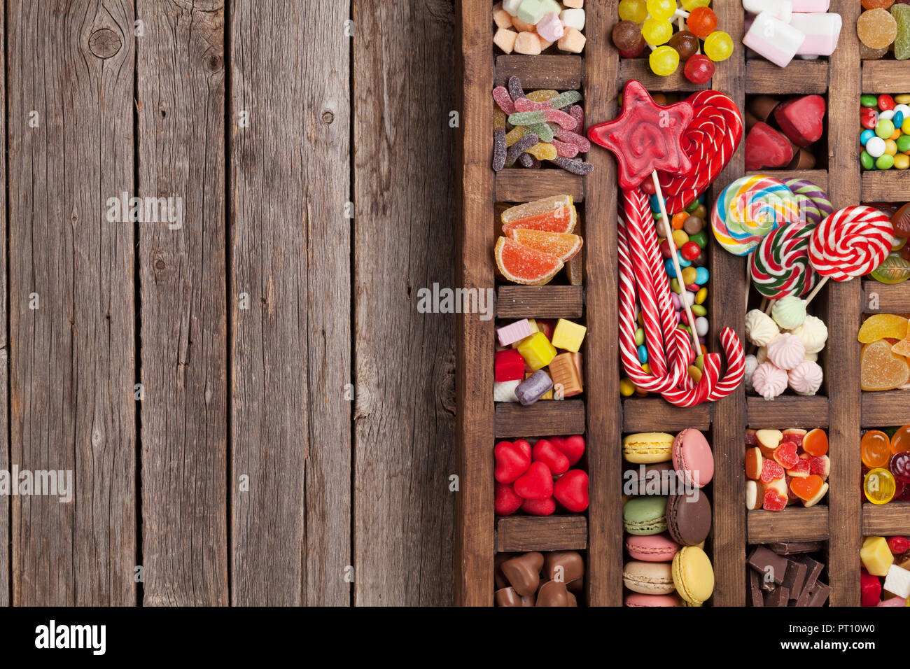 Colorful sweets box. Lollipops, macaroons, marshmallow, marmalade and ...