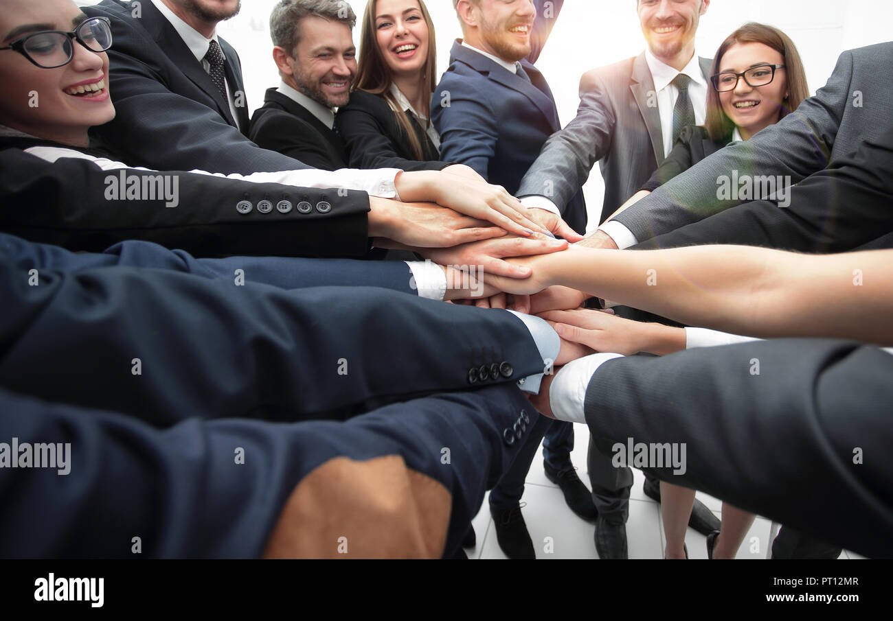 concept of team building. large business team standing with folded ...