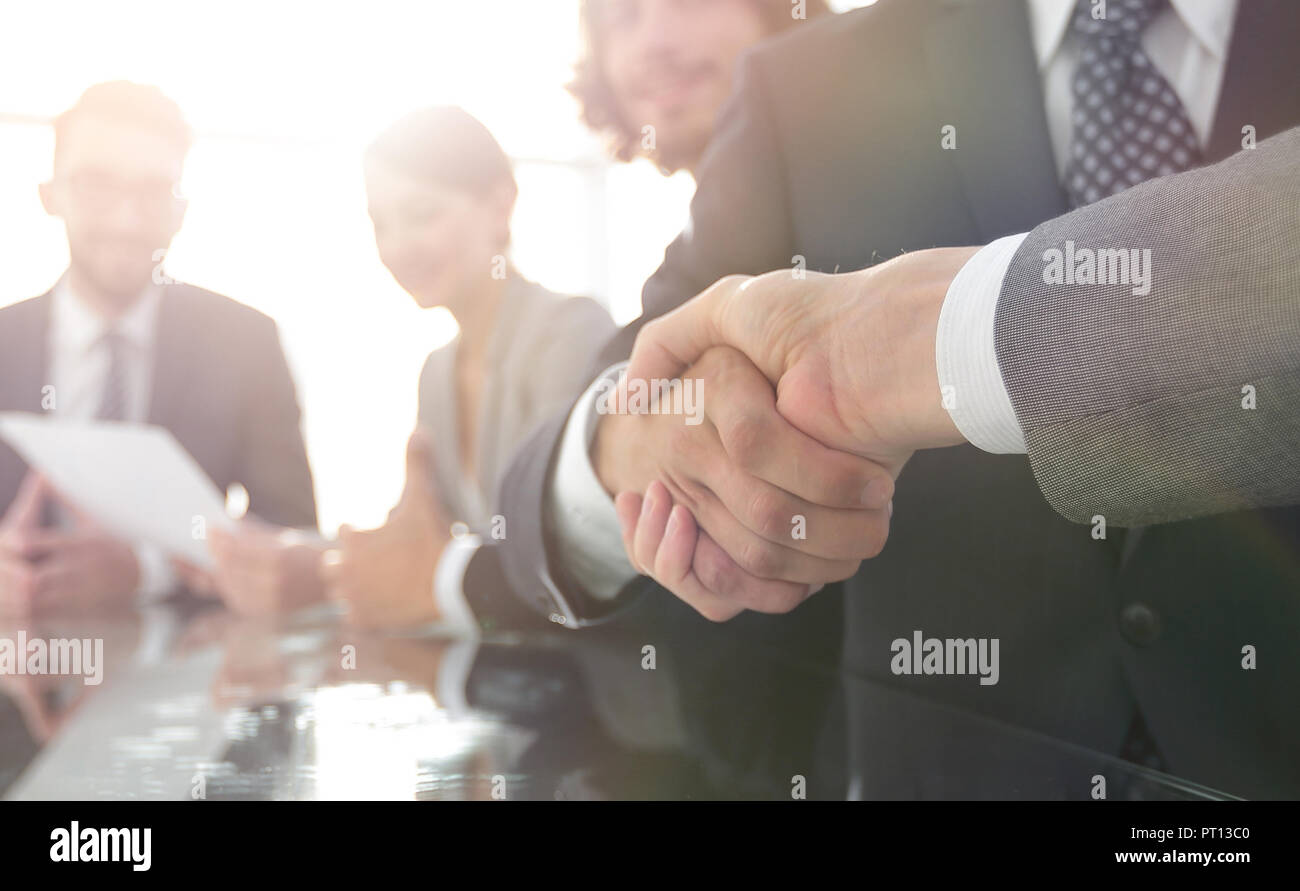 background image of handshake of business partners in conference room ...