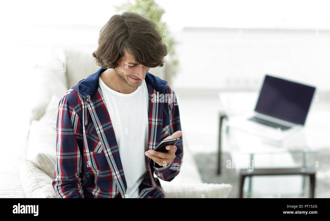 modern guy looking at screen smartphone at home. concept of lifestyle ...