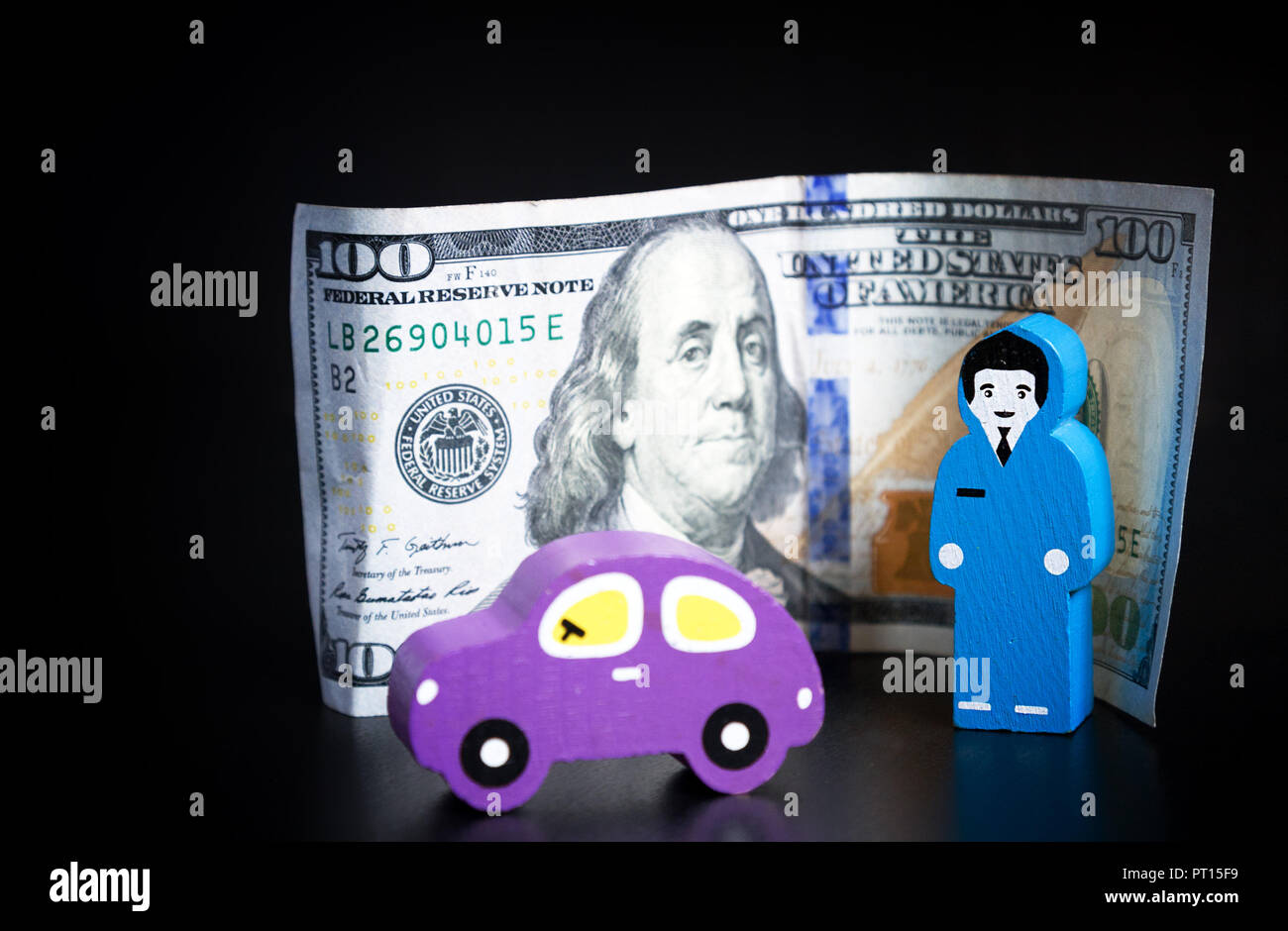 Toy car, dollars and businessmen on black background Stock Photo - Alamy