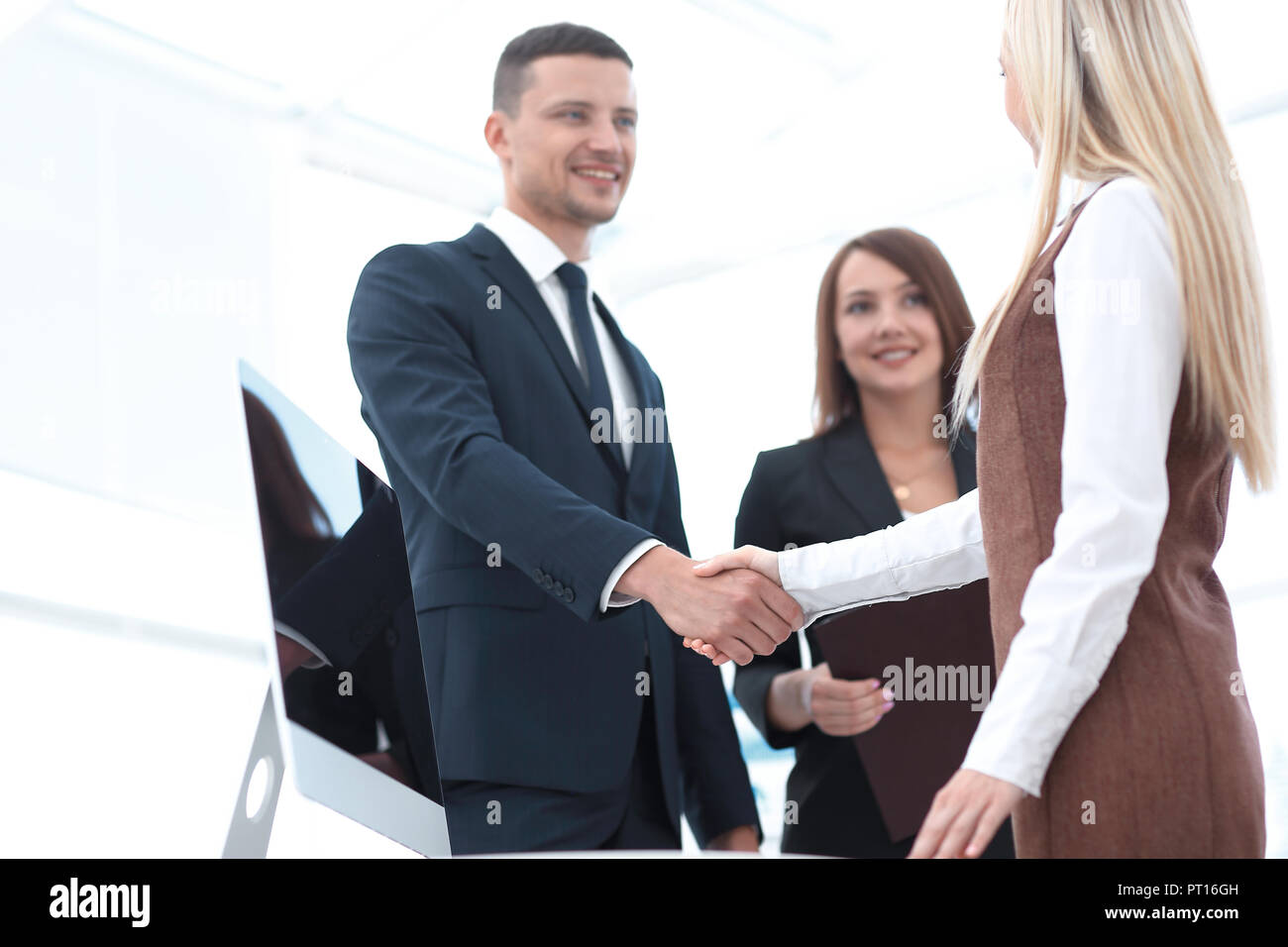 business colleagues shaking hands after a successful presentation ...