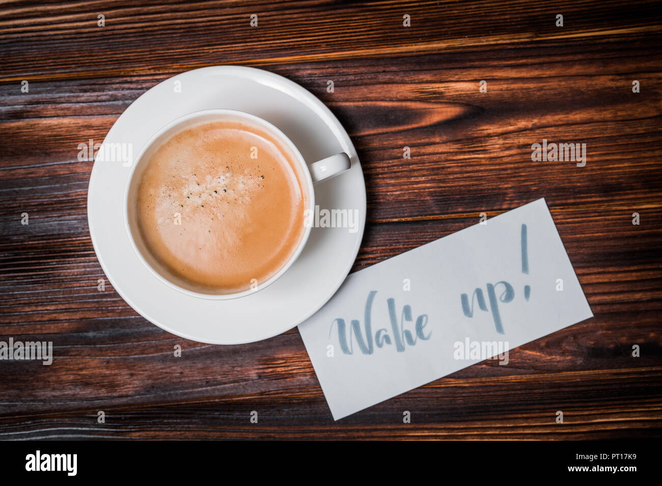 Wake up text near cup of coffee. Font of lettering word on white paper ...
