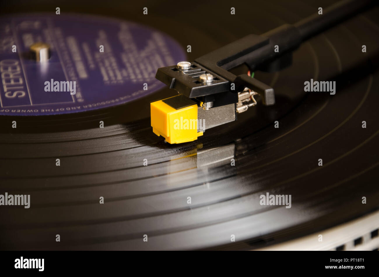 Vinyl record player with focus on turntable cartridge on plate ...