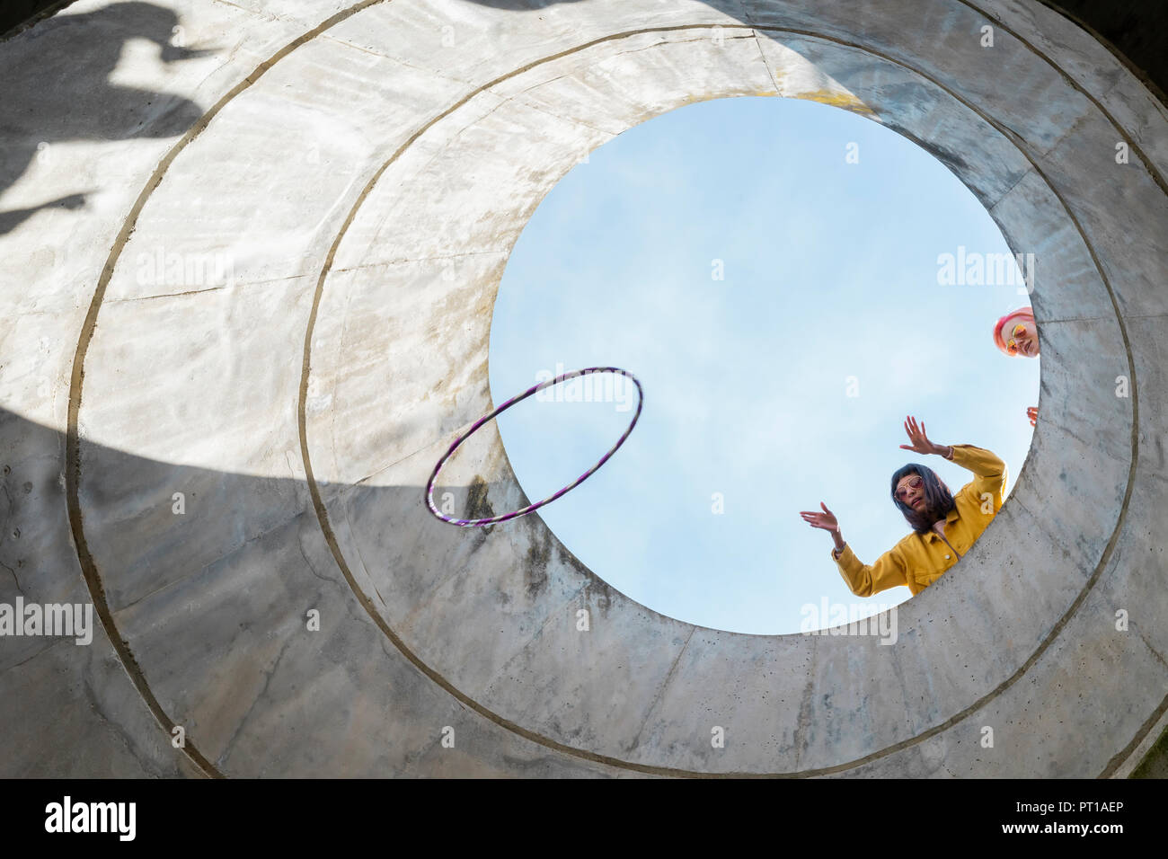 Woman throwing hoop Stock Photo - Alamy