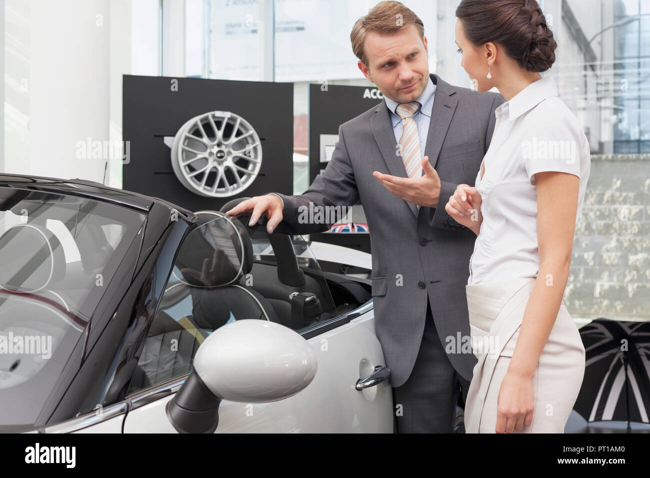 Salesman talking to client convertible car hi-res stock photography and ...