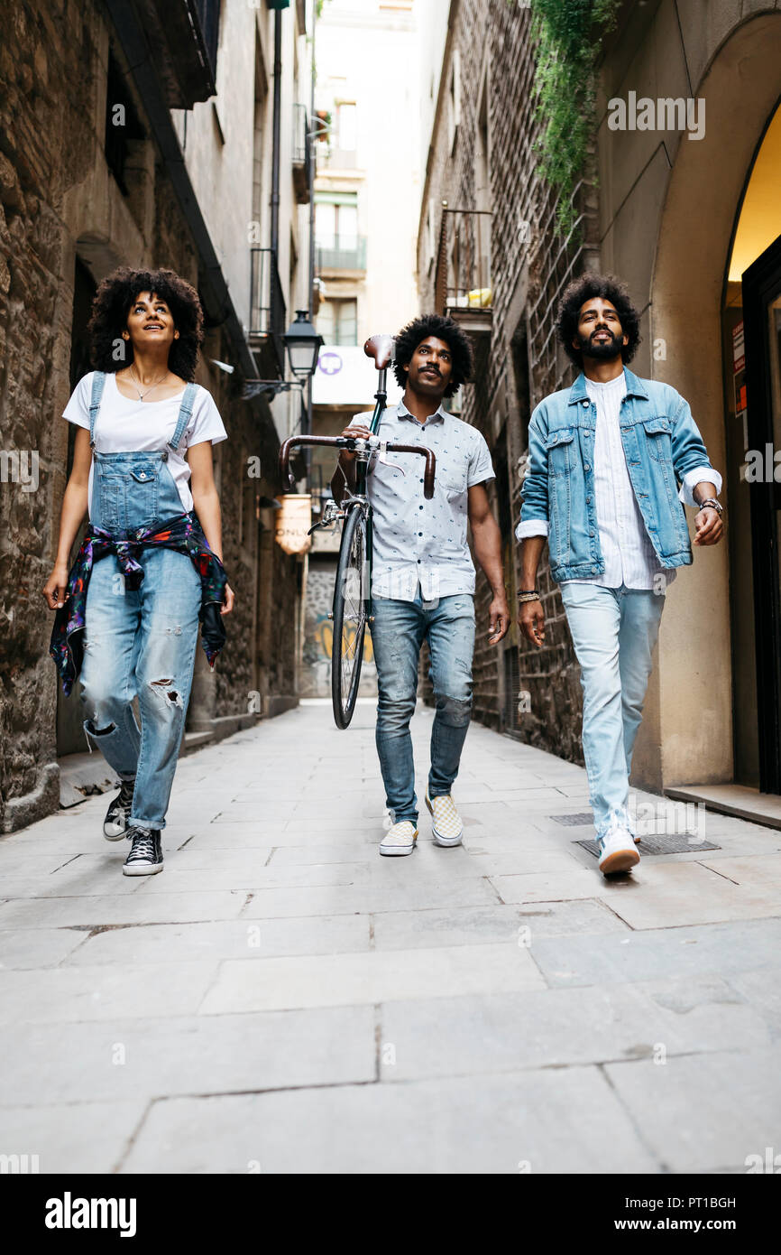 Spain, Barcelona, three friends walking in the city Stock Photo - Alamy