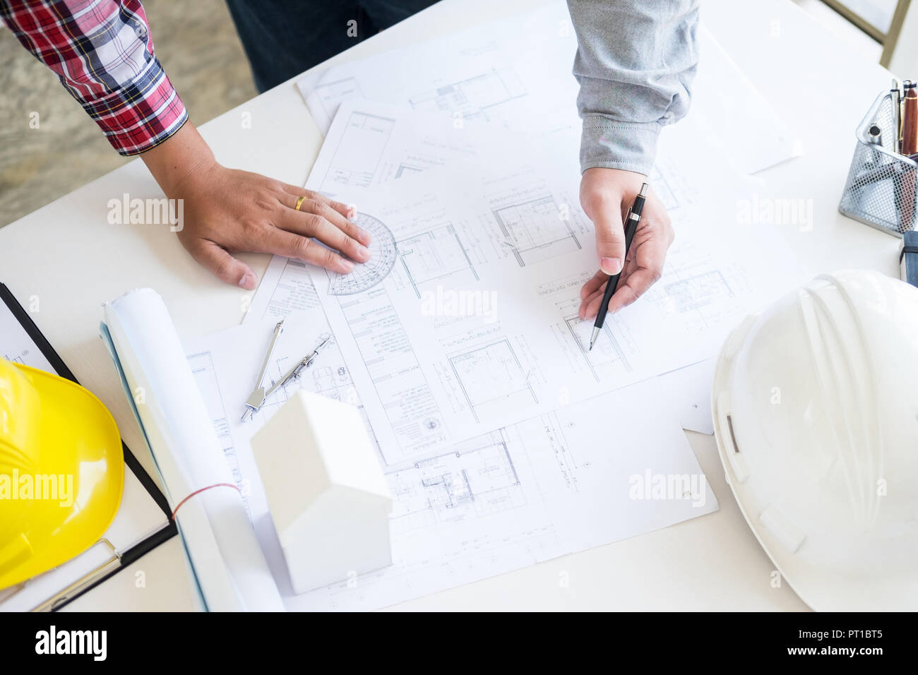 Close-up Of Person's engineer Hand Drawing Plan On Blue Print with ...