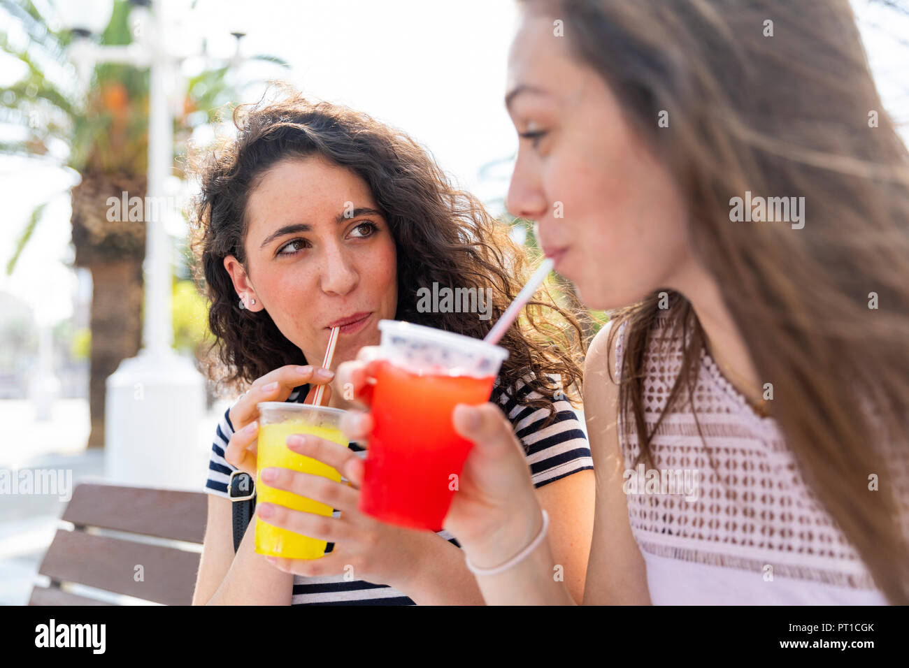 Two female friends enjoying a fresh slush Stock Photo - Alamy