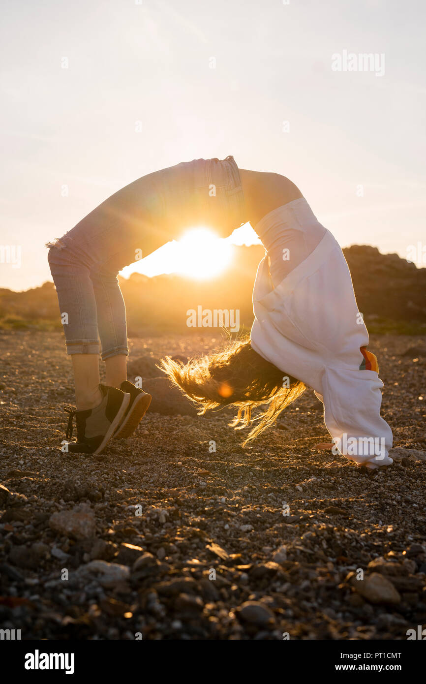 Doing wheel pose sunset hi-res stock photography and images - Alamy