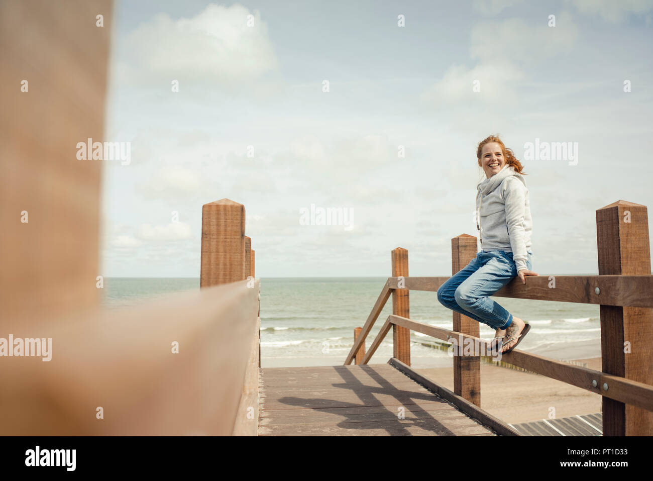 Woman sitting on fence hi-res stock photography and images - Alamy