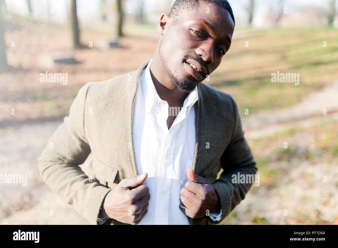 Portrait ogf young man in park, wearing jacket, looking cool Stock ...