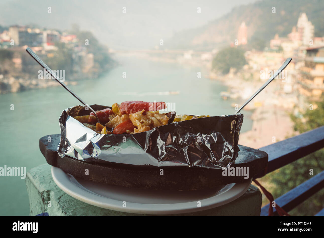 A dish of grilled and stewed vegetables in foil on the background of ...