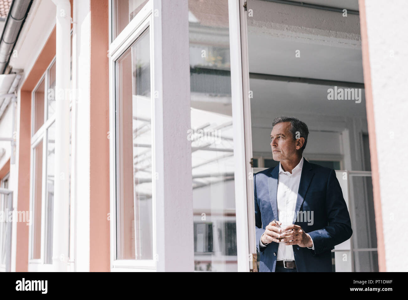 Mature businessman watching something Stock Photo - Alamy