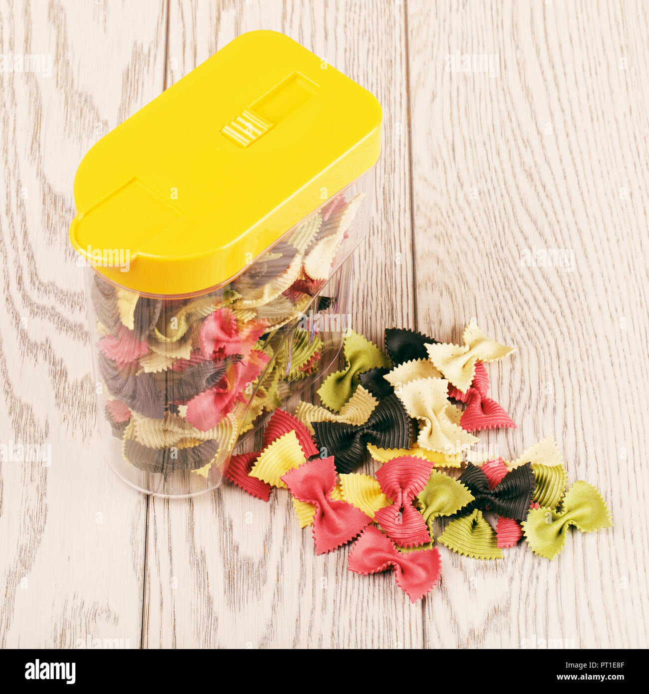 raw bow-knot pasta of different color in plastic container Stock Photo ...