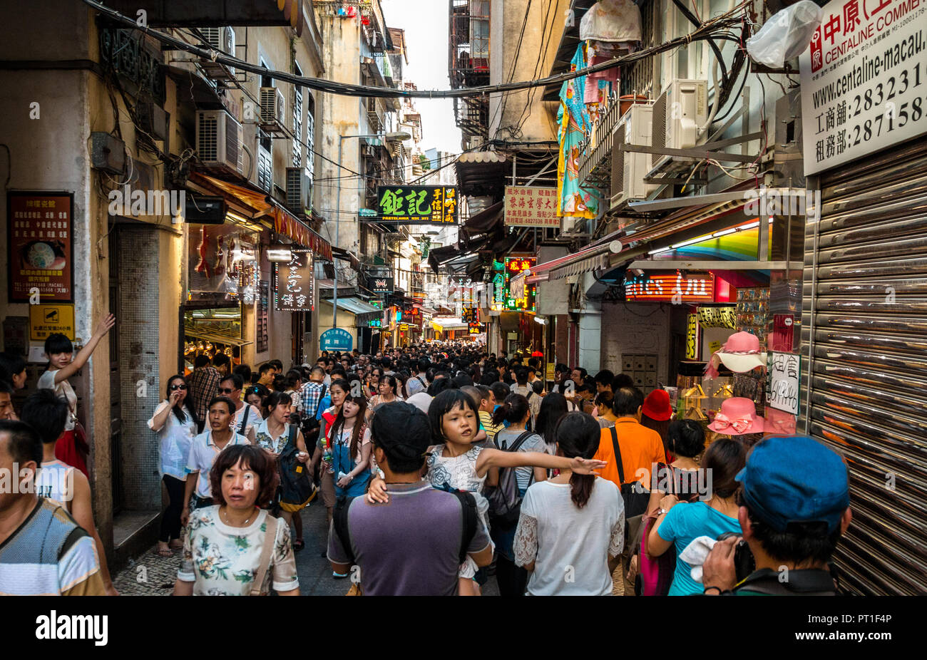 Macau, China - JULY 11, 2014: Big crowd of tourists walking on the famous narrow "Rua de Sao ...