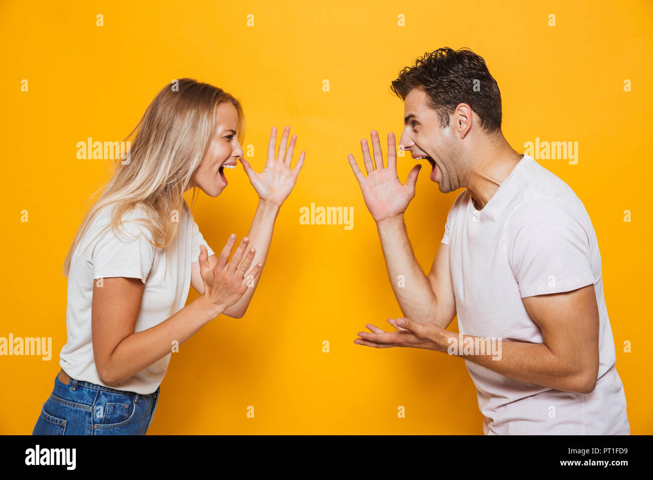 Photo of displeased young loving couple screaming standing isolated ...