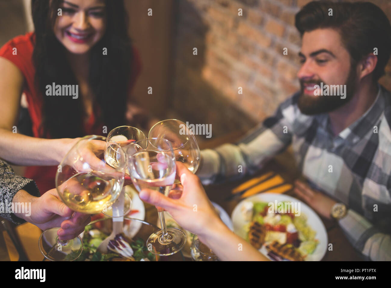 Family and friends enjoying dinner, eating, drinking, having fun Stock ...