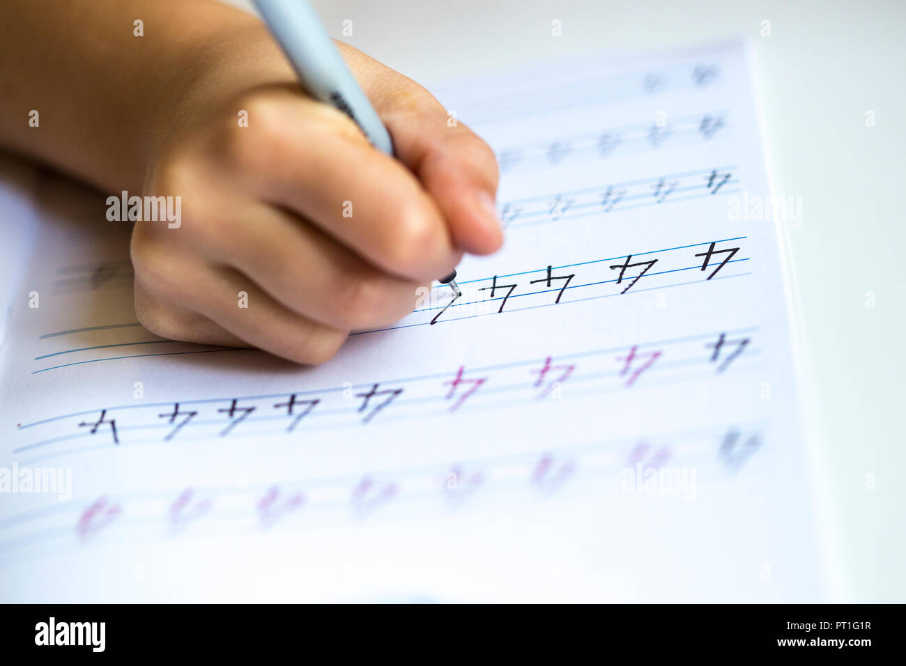 Hand of little girl writing numbers in exercise book, close-up Stock ...