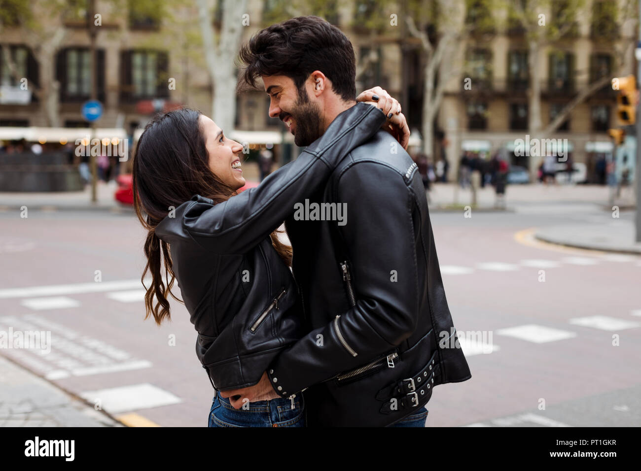 Spain, Barcelona, happy young couple hugging on the street Stock Photo ...