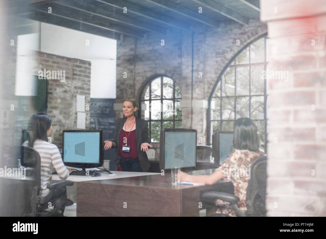 Adult Education, students receiving lesson at computer training centre ...