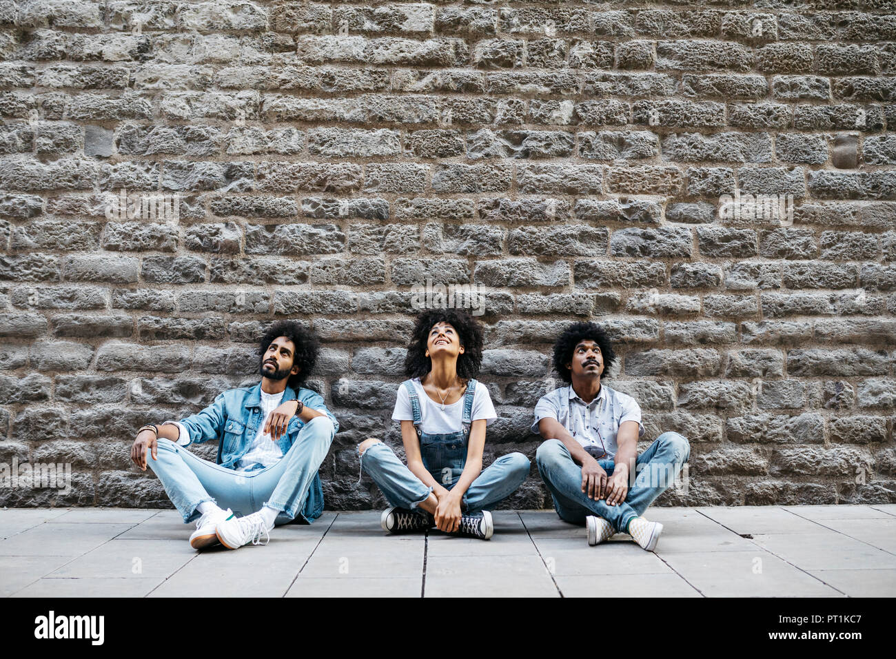 Three friends sitting together hi-res stock photography and images - Alamy