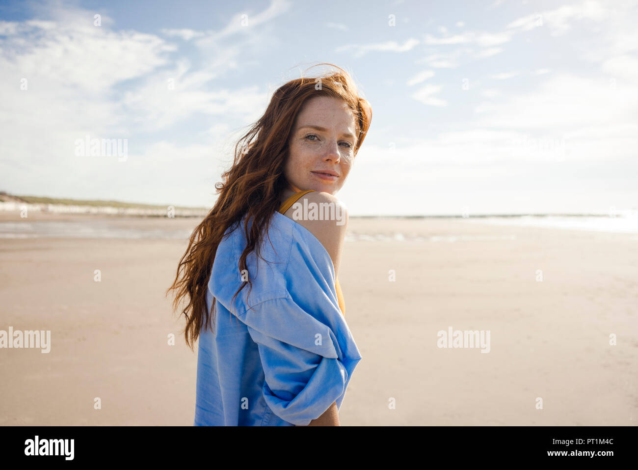 Woman on the beach, looking over shoulder Stock Photo - Alamy