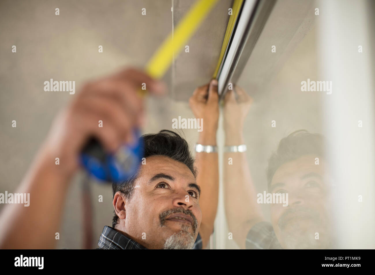 Man measuring window frame Stock Photo - Alamy Man measuring window frame Stock Photo - Alamy