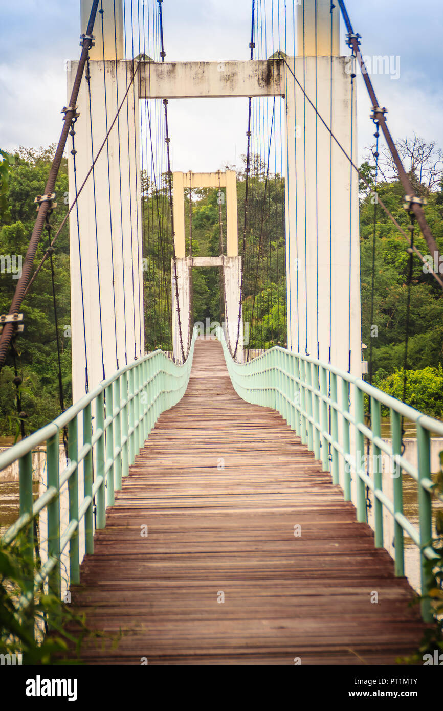 Vintage suspension bridge hanging across the river. Old lengthy hanging ...
