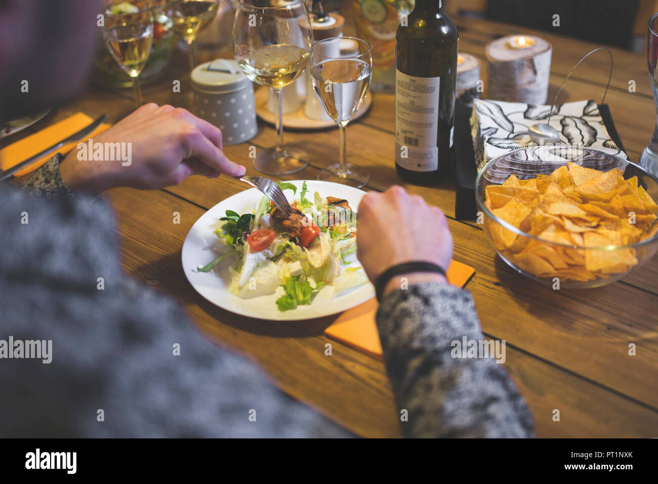 Man eating at dinner with friends Stock Photo - Alamy