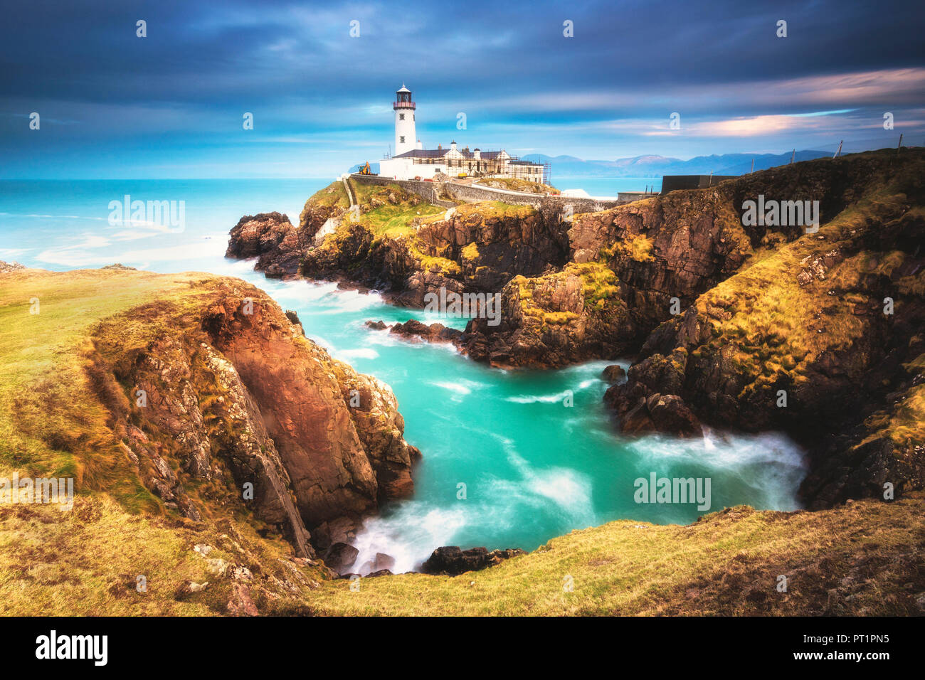 Photographer on the field at sunrise near fanad head lighthouse hi-res ...