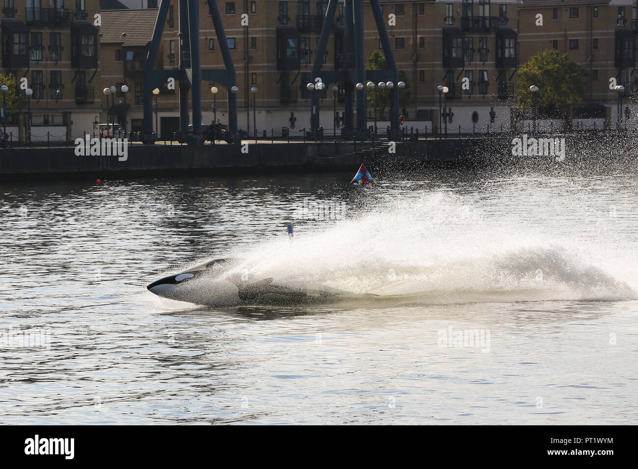 London's Royal Docks. UK 5 Oct 2018 - Man riding a whale shaped jet-ski ...