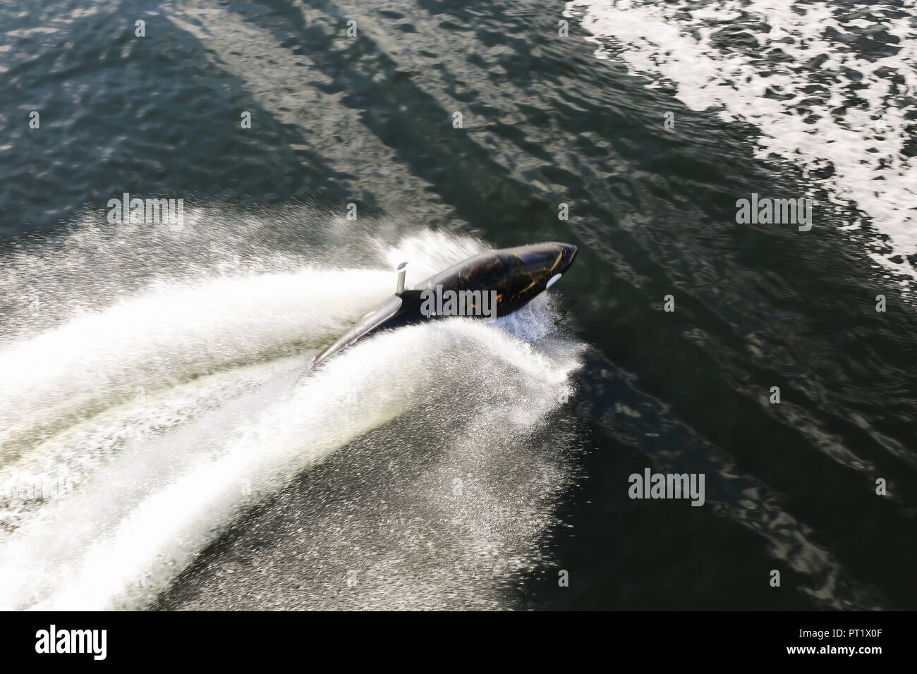 London's Royal Docks. UK 5 Oct 2018 - Man riding a whale shaped jet-ski ...