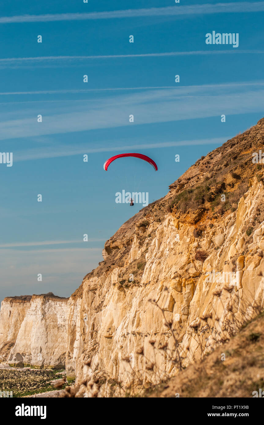 Newhaven East Sussex, UK..5 October 2018..Paragliders flying along the ...