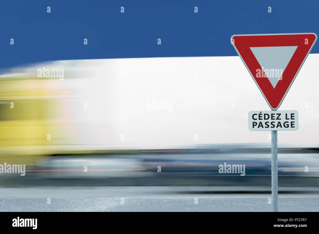Give way yield french cédez le passage road sign, motion blurred truck ...