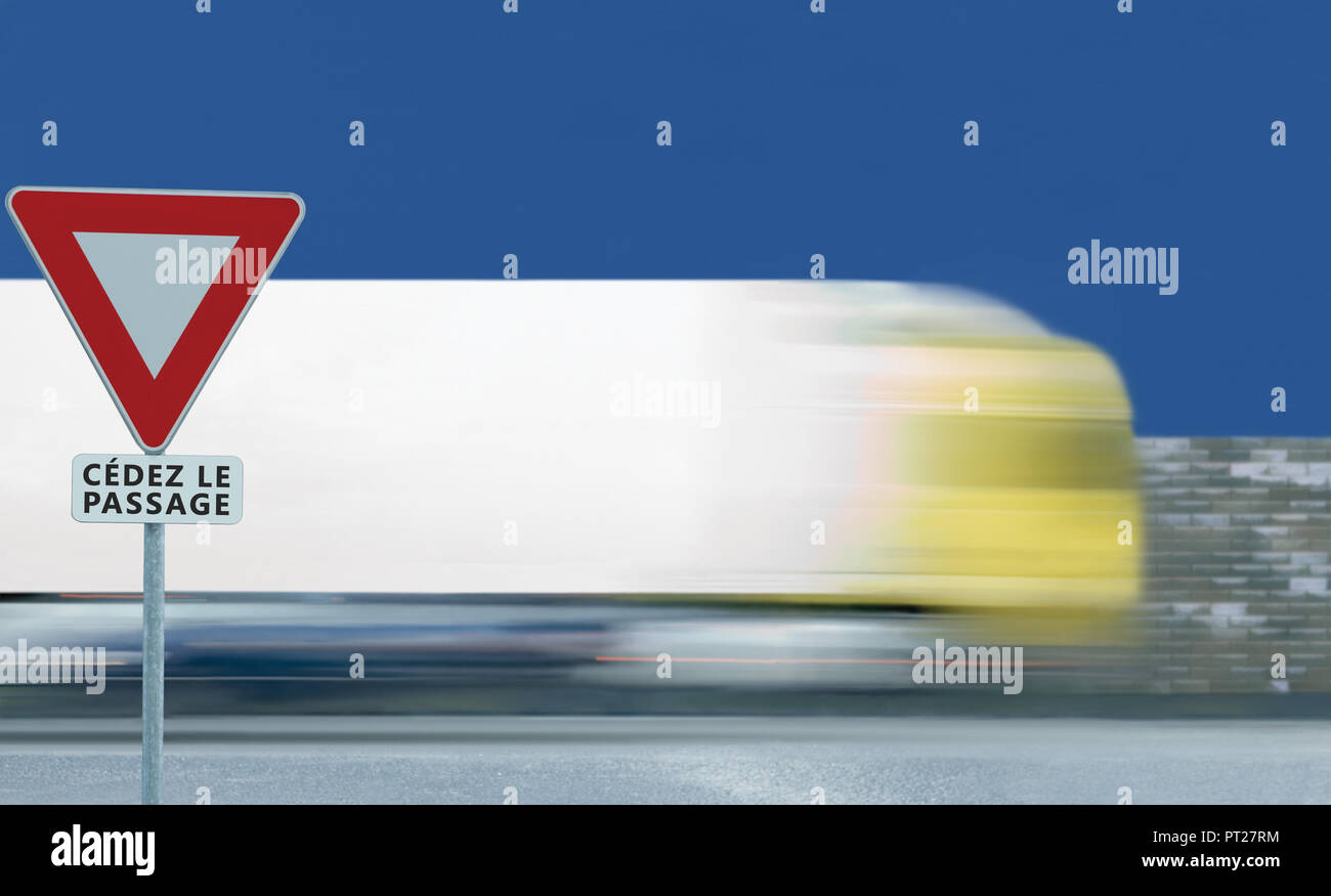 Give way yield french cédez le passage road sign, motion blurred truck ...