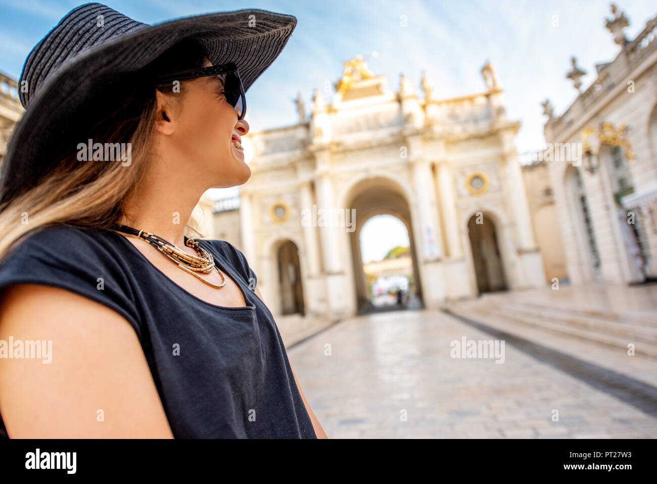 Young woman tourist enjoying beautiful triumphal arch traveling in ...