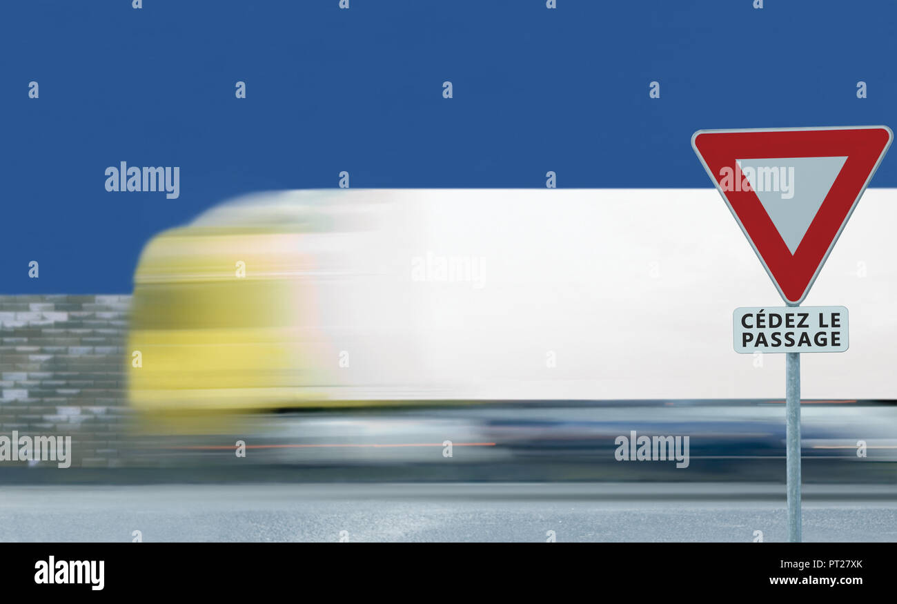 Give way yield french cédez le passage road sign, motion blurred truck ...