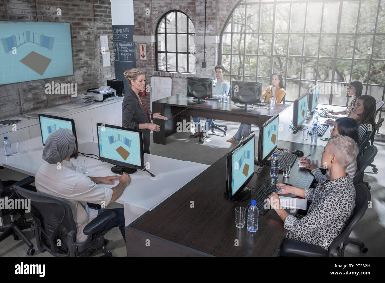 Adult Education, students receiving lesson at computer training centre ...